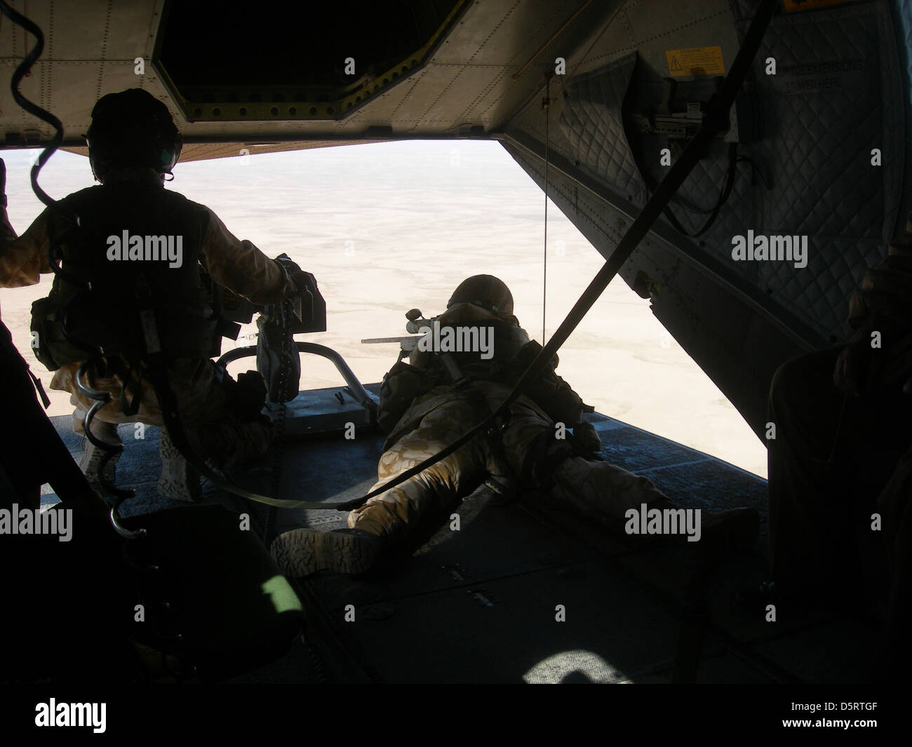 a British sniper shoots from the back of a merlin helicopter ops in ...