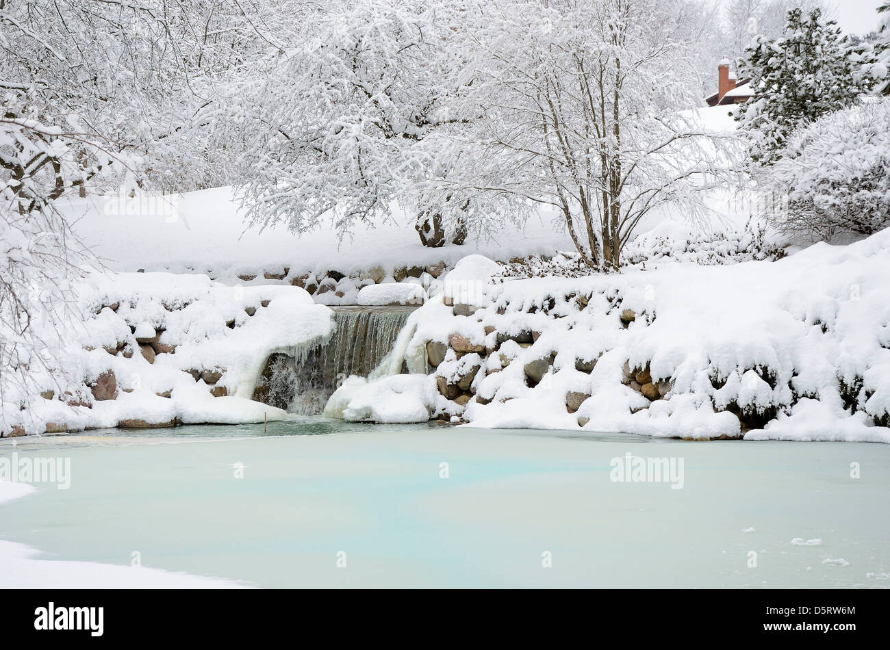 Snow covered waterfall and pond Stock Photo - Alamy