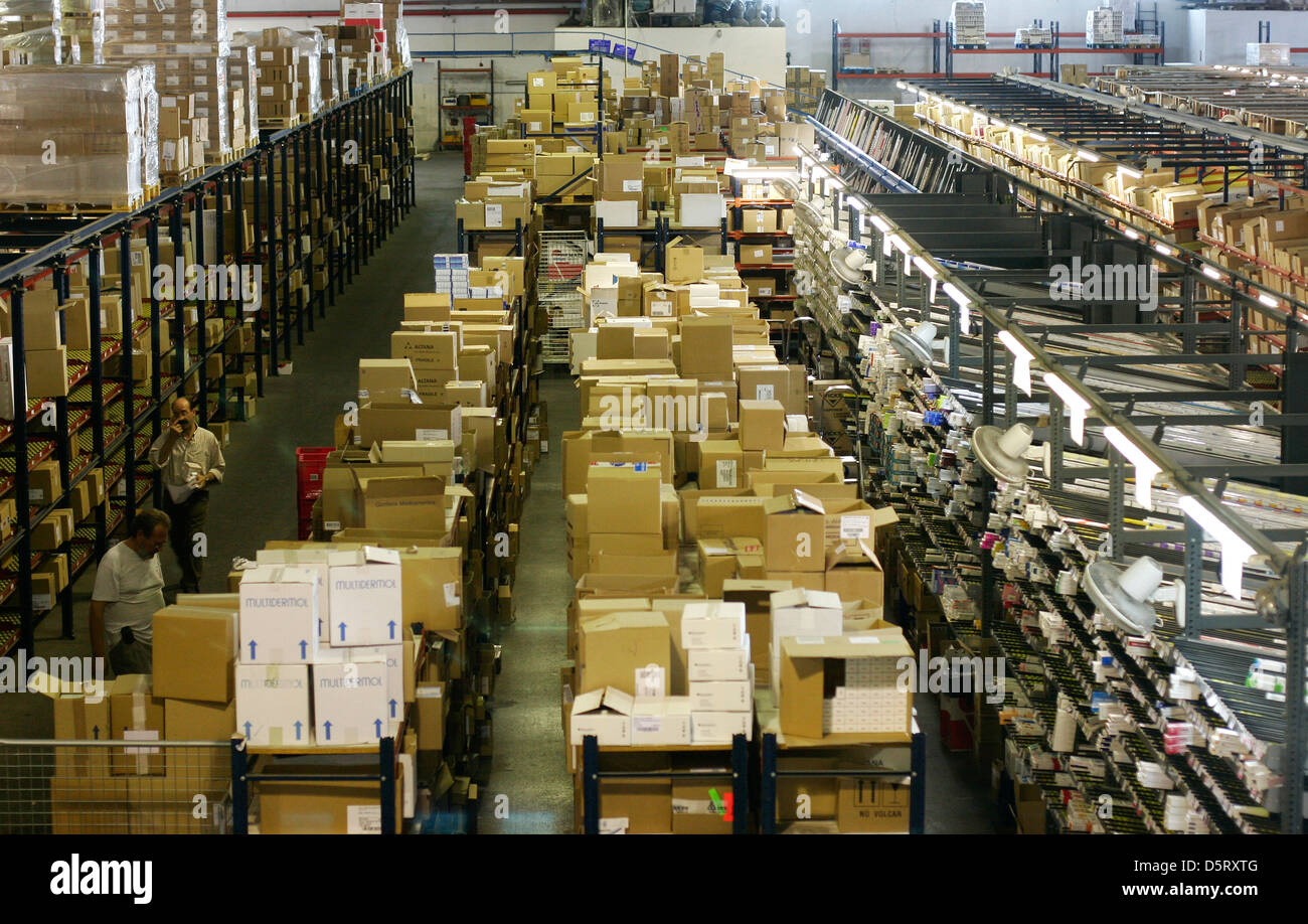 workers are seen surrounded by packages inside a pharmaceutical ...