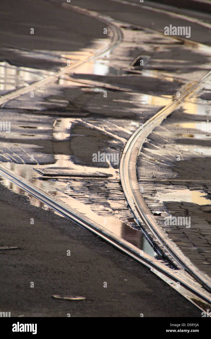 crossing tram lines in city town Stock Photo - Alamy