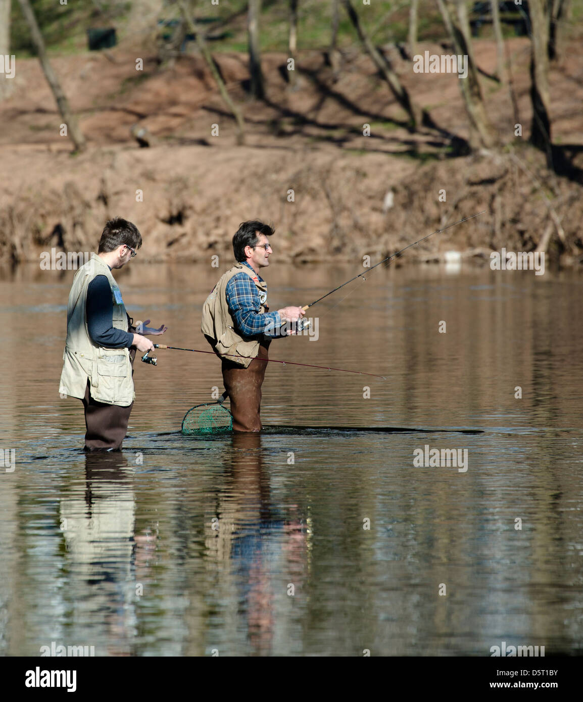 Two fisherman wading in a river. Water up to their knees Stock Photo ...
