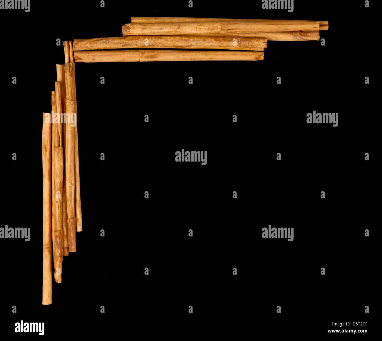 Cinnamon frame on black background Stock Photo - Alamy