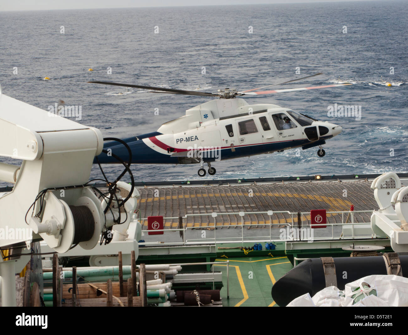 Helicopter landing in the landing deck of the offshore seismic vessel ...