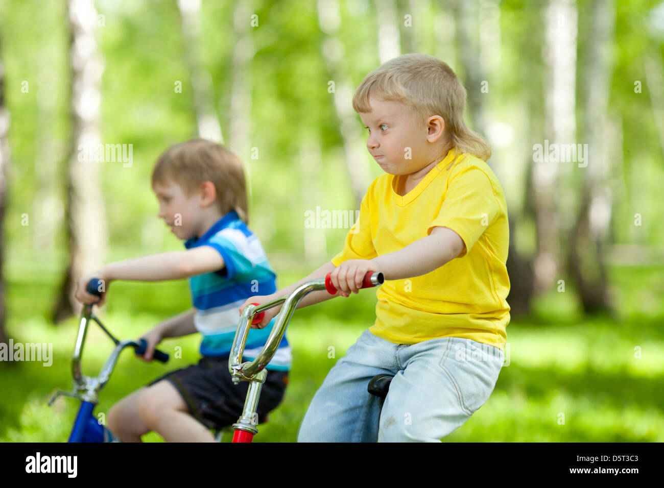 little children riding their bikes in park Stock Photo - Alamy