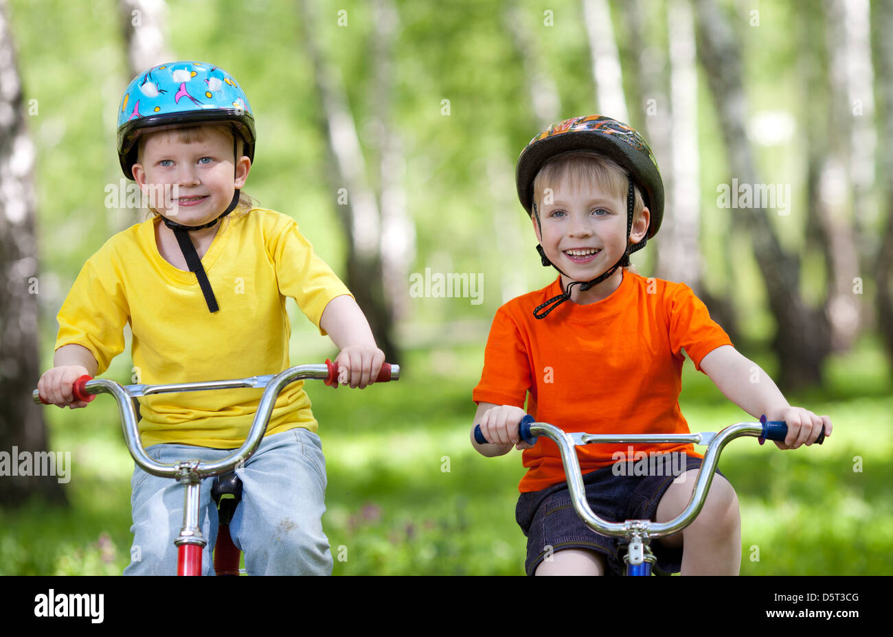 little children riding their bikes in park Stock Photo - Alamy