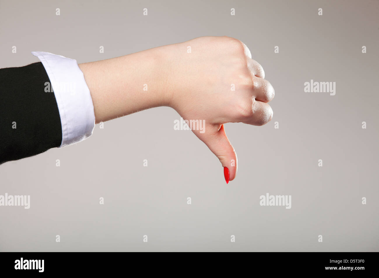 Business woman's thumb down hand sign gray background Stock Photo - Alamy