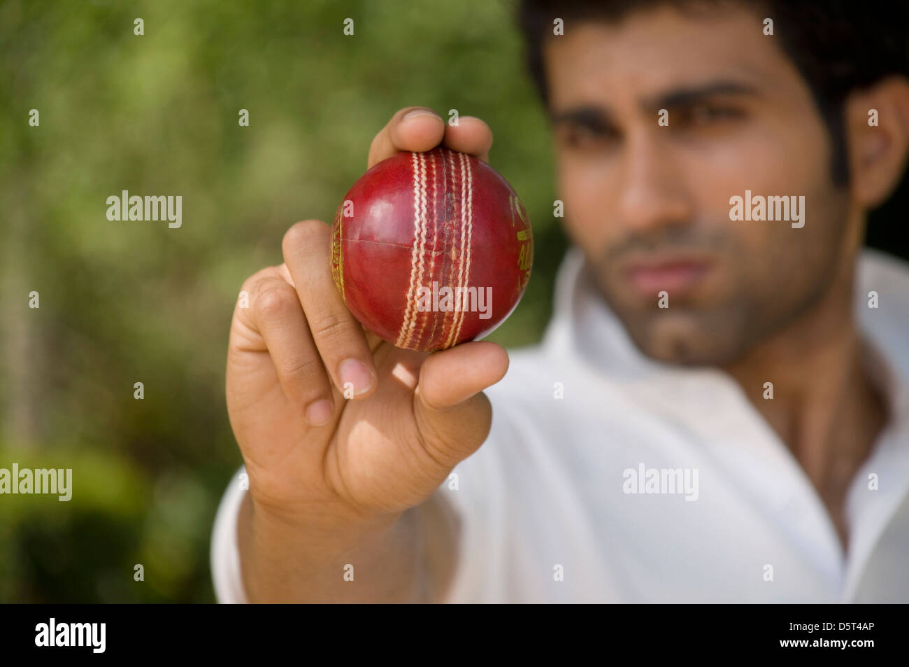 Close-up of bowler holding cricket ball Stock Photo - Alamy