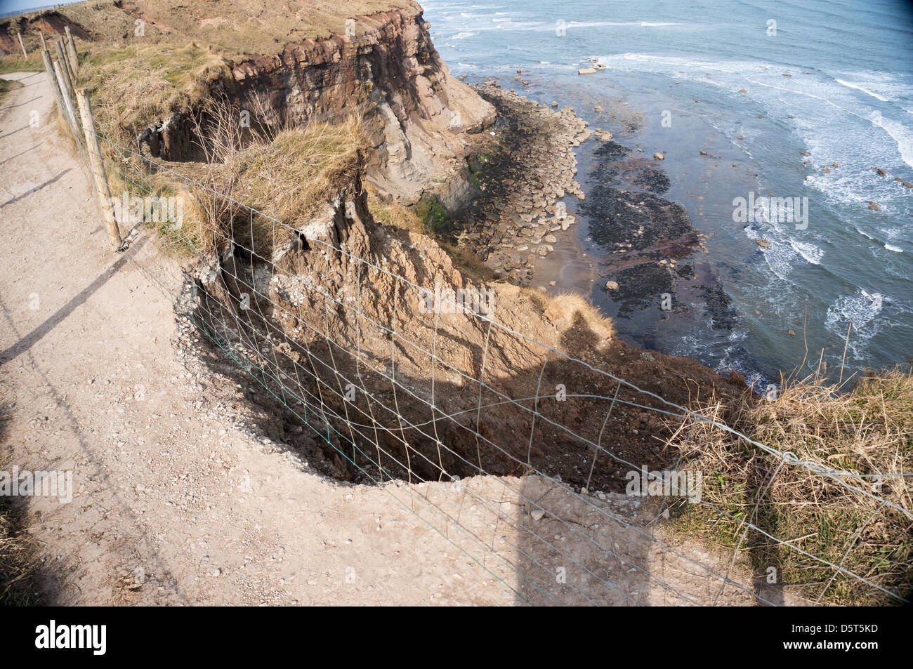 View showing severe erosion of the coastal path or Cleveland way ...