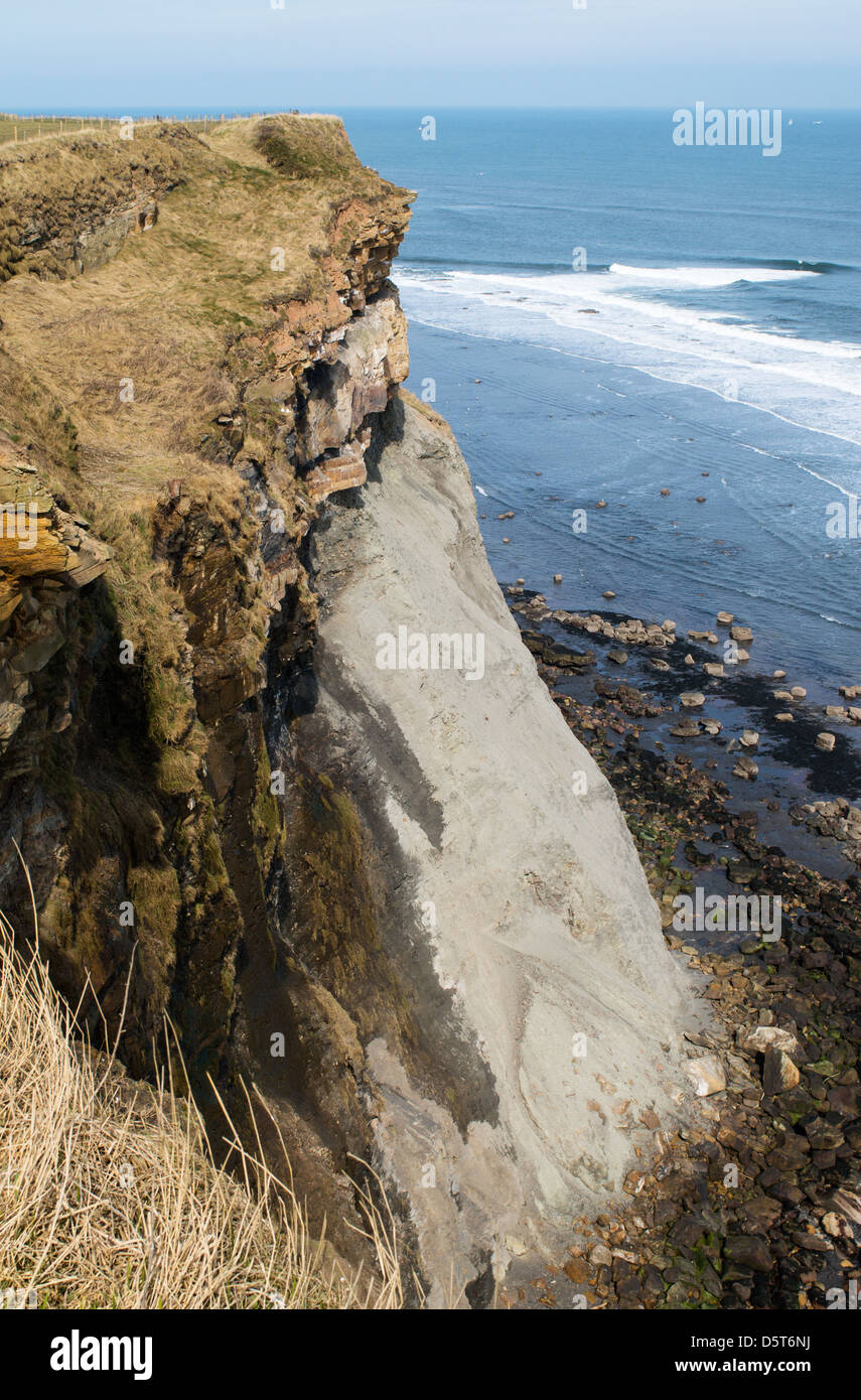 Grey coloured rock formation seen from the Cleveland Way cliff top path ...