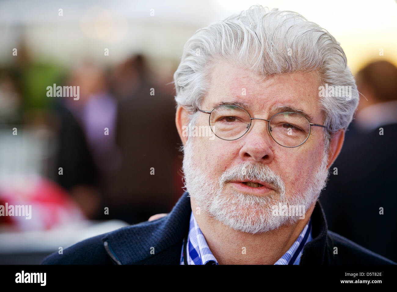 US Film Producer George Lucas walks through the paddock at the Circuit ...