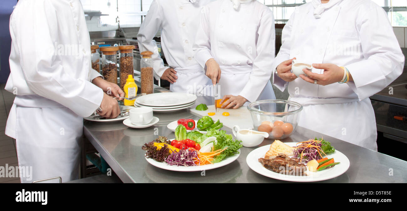 A senior chef giving cooking lesson to young chefs Stock Photo - Alamy