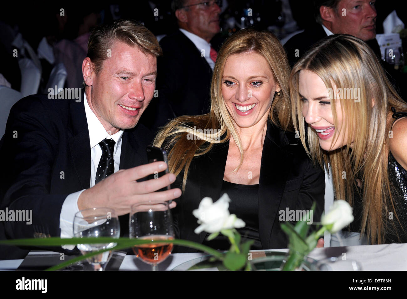 Former Finnish racing driver Mika Haekkinen (L-R), his partner Marketa ...