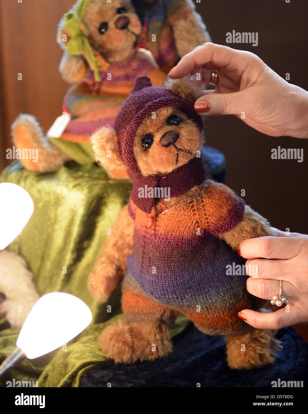 An exhibitor prepares a teddy bear at the 16th soft toy fair ...