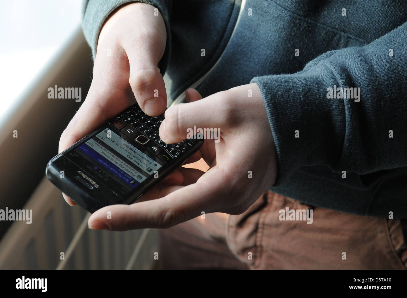 Teenage Boy Using A Mobile Phone Stock Photo - Alamy