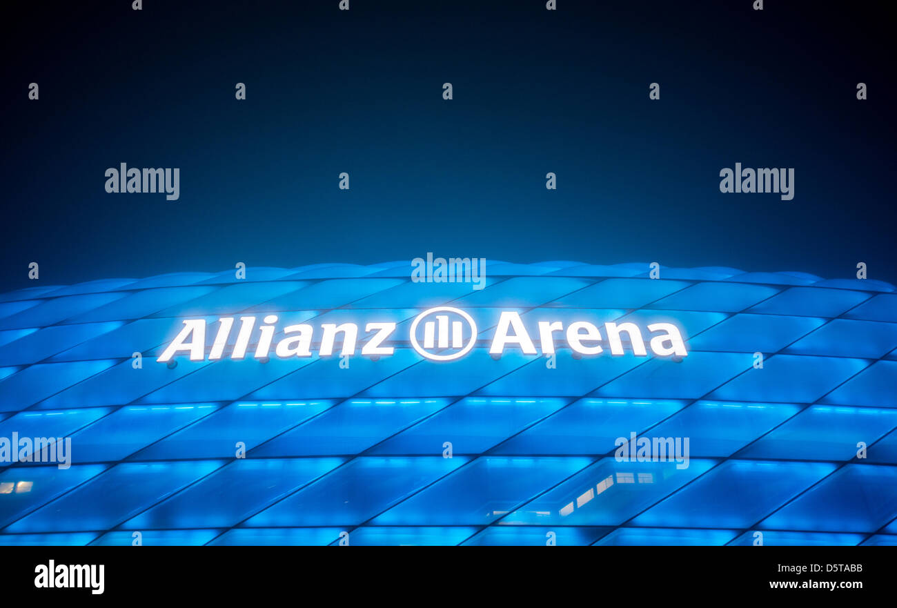 the Allianz Arena is illuminated in blue light with the logo of the ...