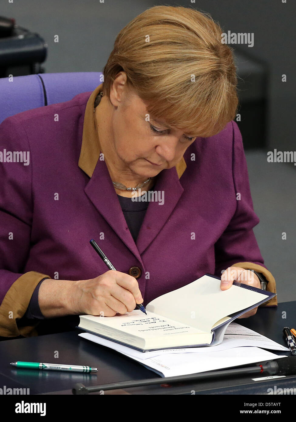German Chancellor Angela Merkel signs the book 'Dialog über ...