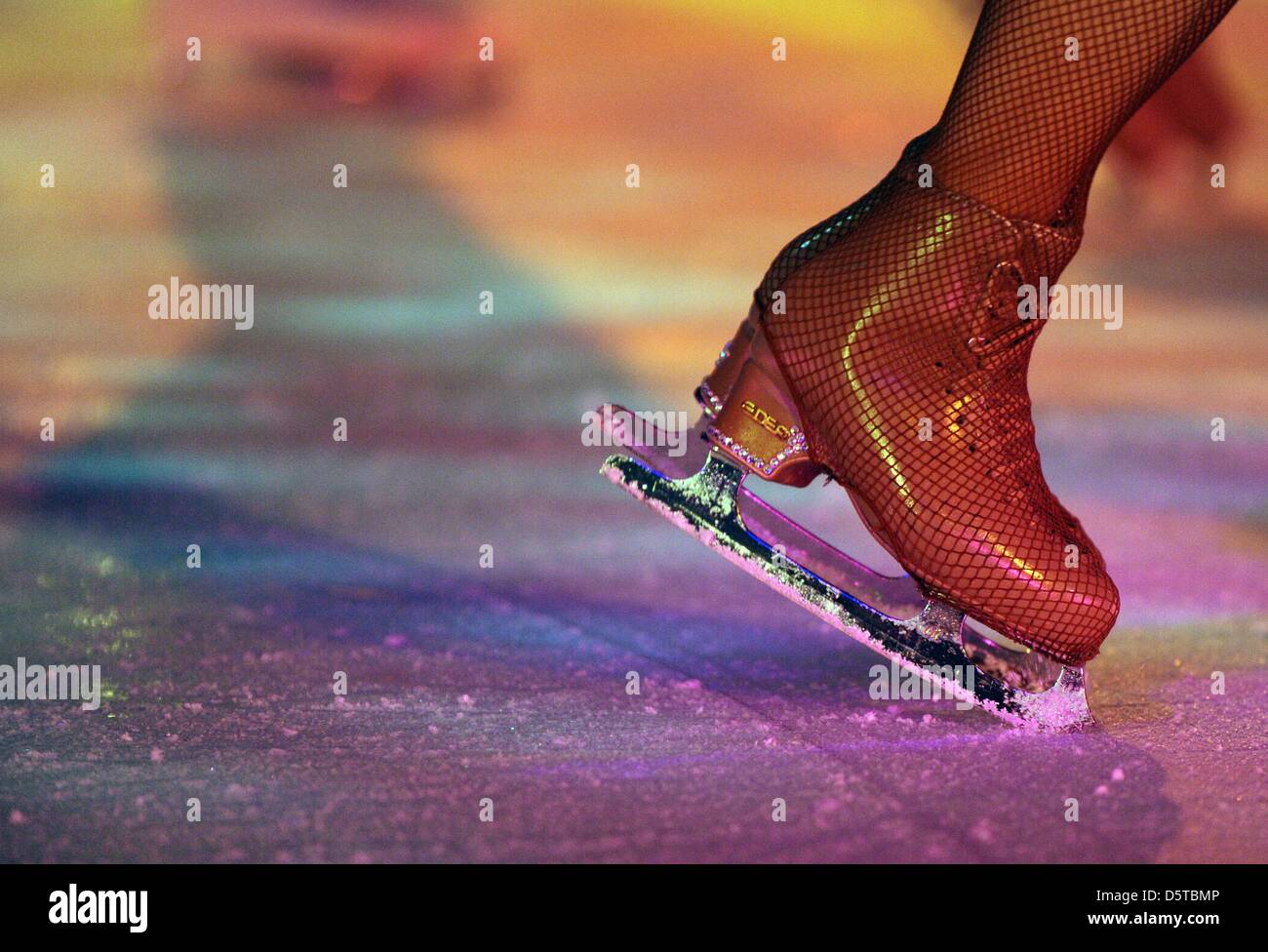 An ice-skate is pictured on colorfully lit ice during an ice show at ...