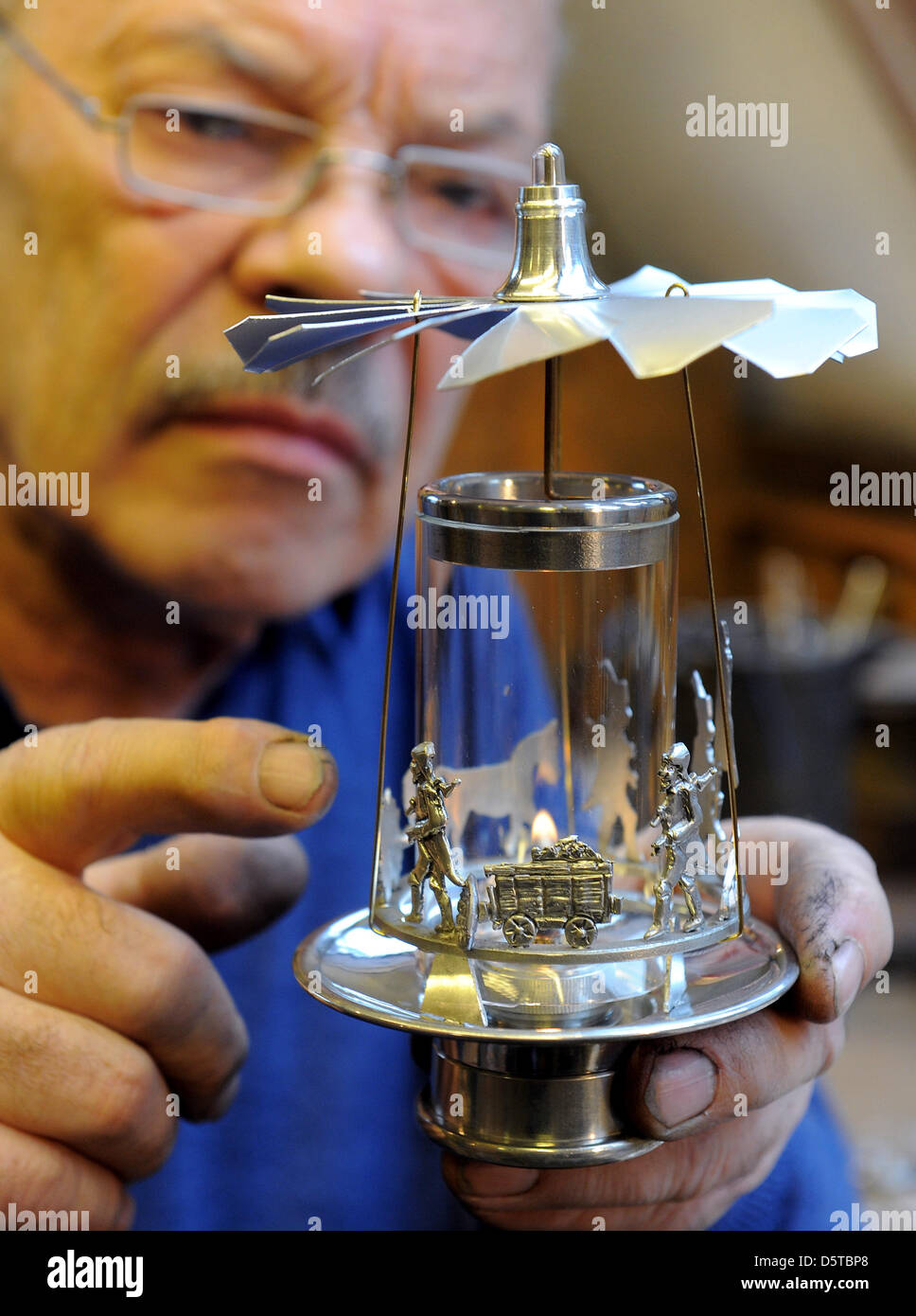 Pewterer Lutz Werner checks the funktion of a pewter mine pyramid in ...