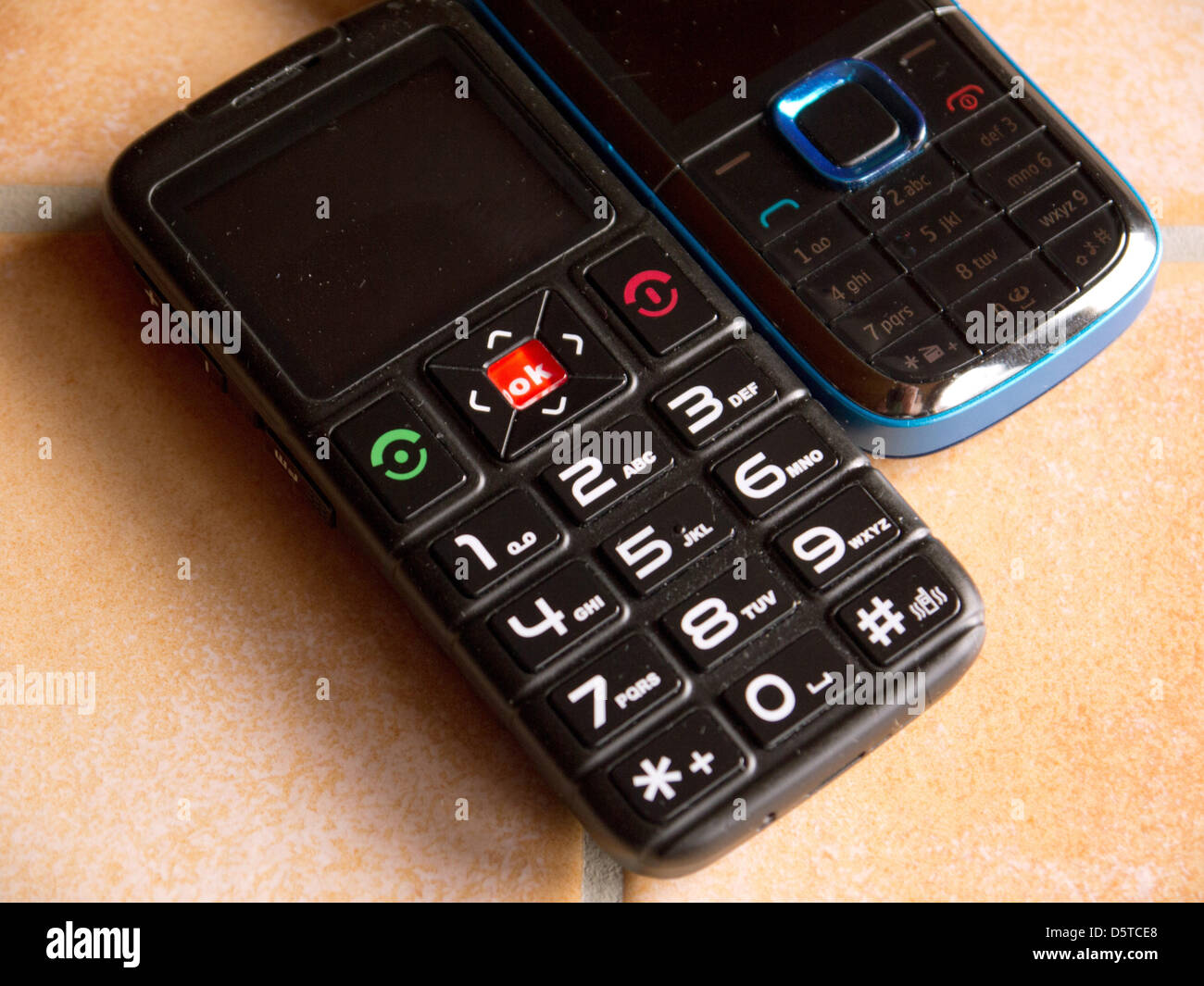 Two mobile phones with large keys for senior citizens are on display on ...