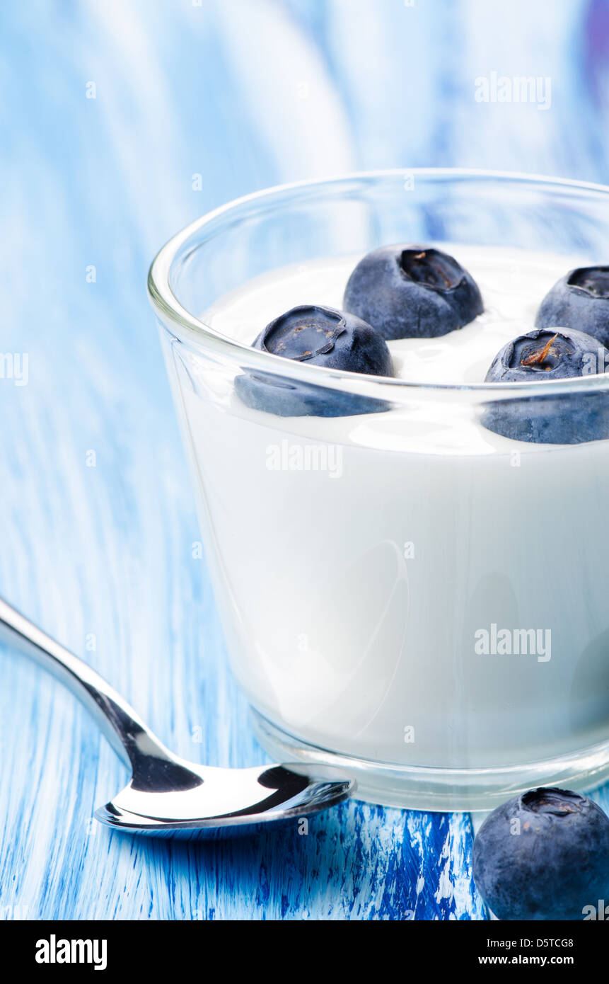 Blueberry yogurt in a glass on blue Stock Photo - Alamy