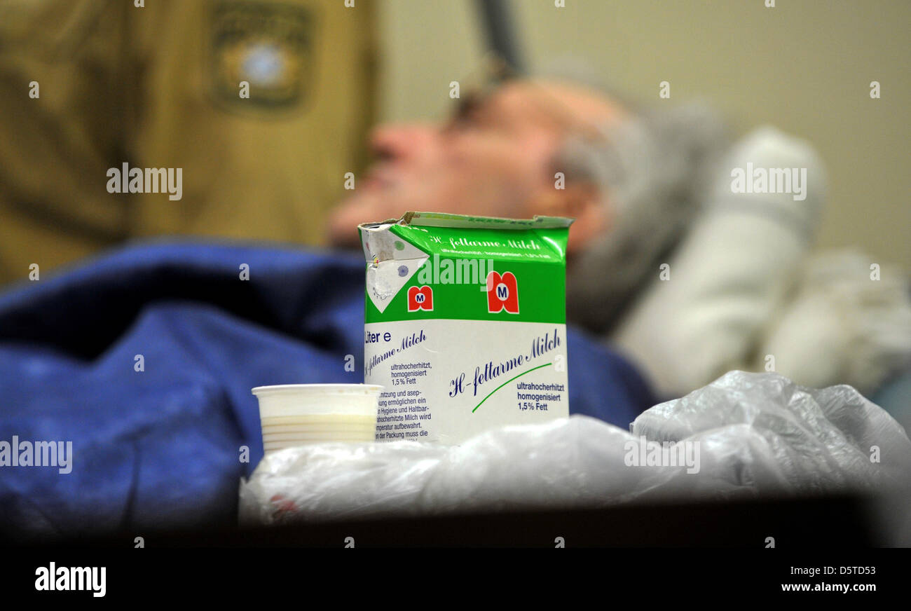 Defendant Rudolf U. (R) lies on a hospital bed at the district court in ...
