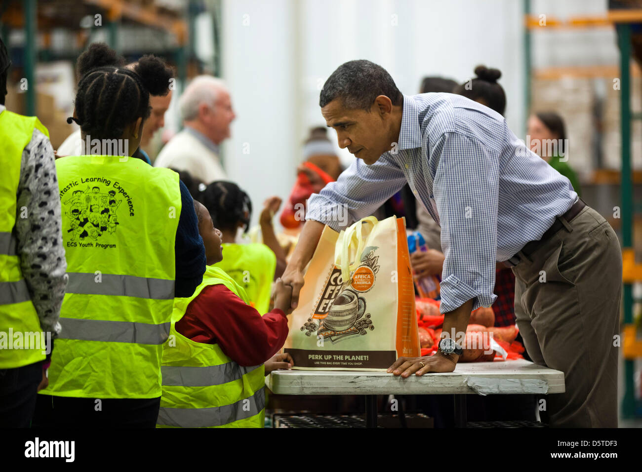 United States President Barack Obama hands out food to the needy for ...