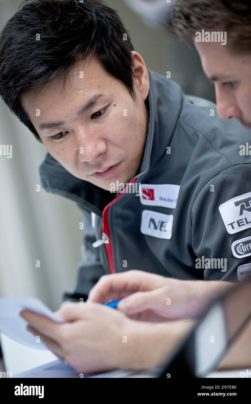 Japanese Formula One driver Kamui Kobayashi of Sauber has a chat in the ...
