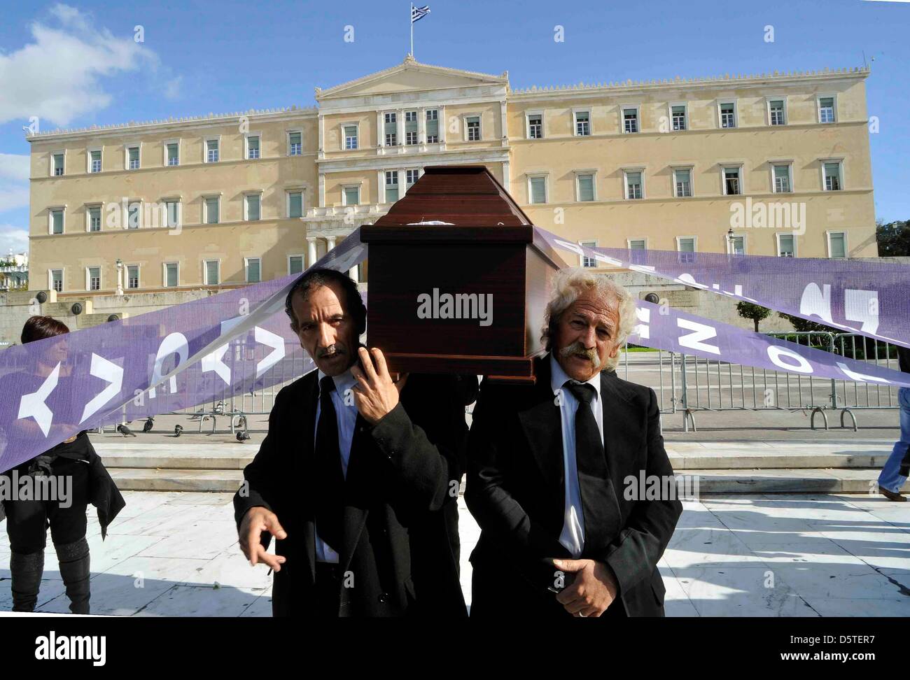 Municipal workers carry a coffin during protest actions against plans ...