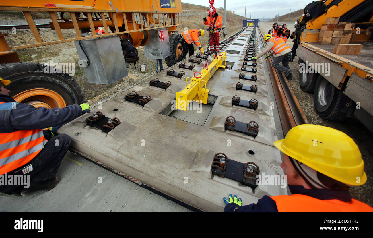 Workers lay so-called track support plates at the new ICE line between ...