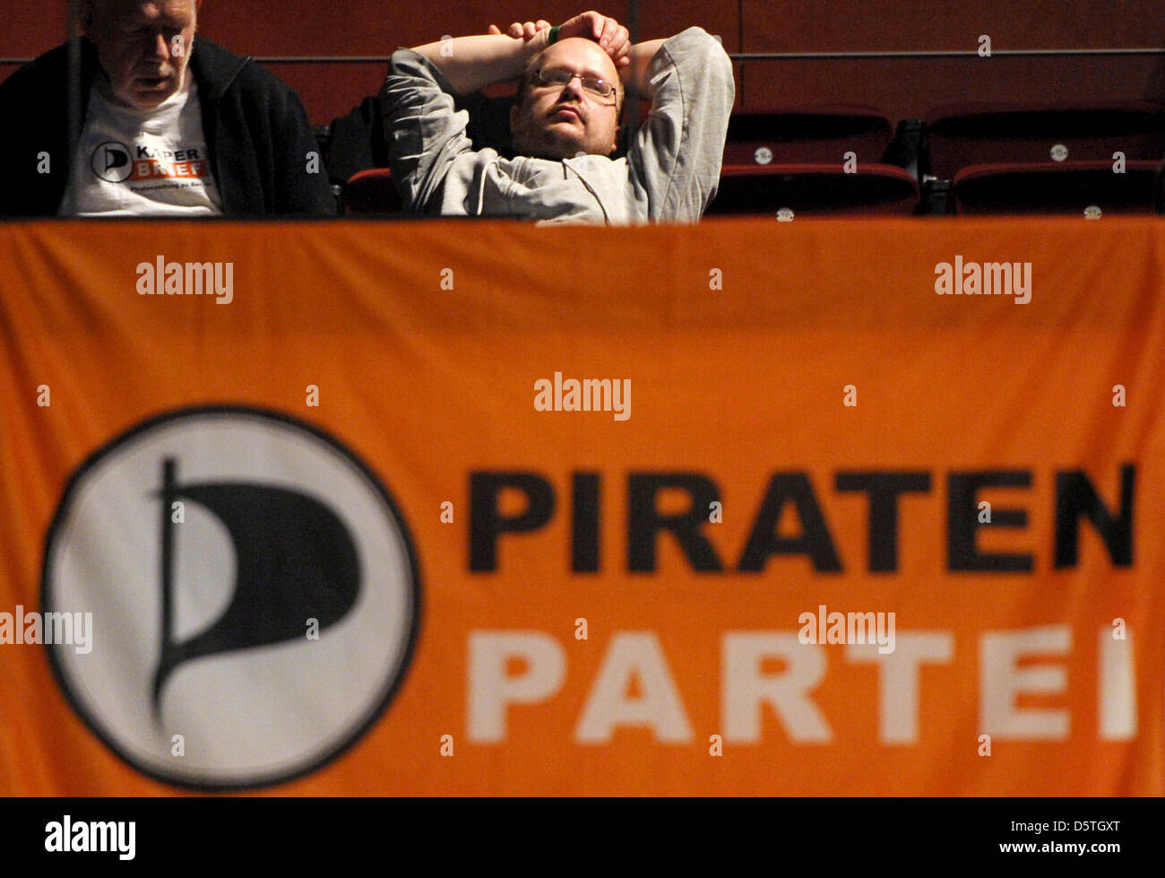 A member of the Pirate Party puts his arms behind his head during the ...
