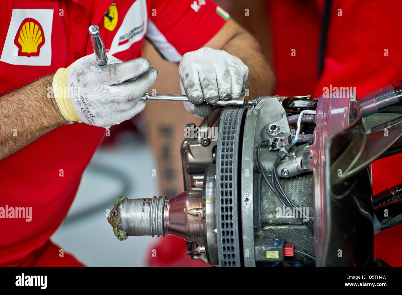 Ferrari engineer works at the brake system of the car of Spanish ...