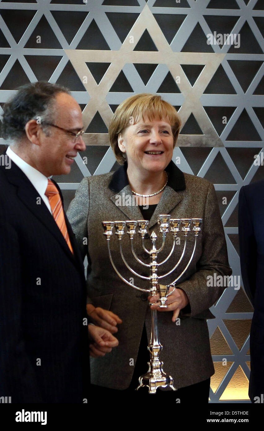 German Chancellor Angela Merkel receives a Hanukkah menorah from the ...