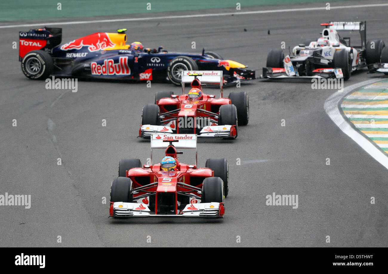 Spanish Formula One driver Fernando Alonso (front) of Ferrari steers ...
