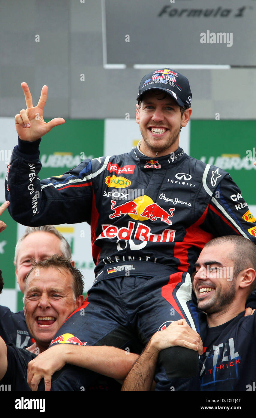 German Formula One driver Sebastian Vettel (C) of Red Bull Racing ...