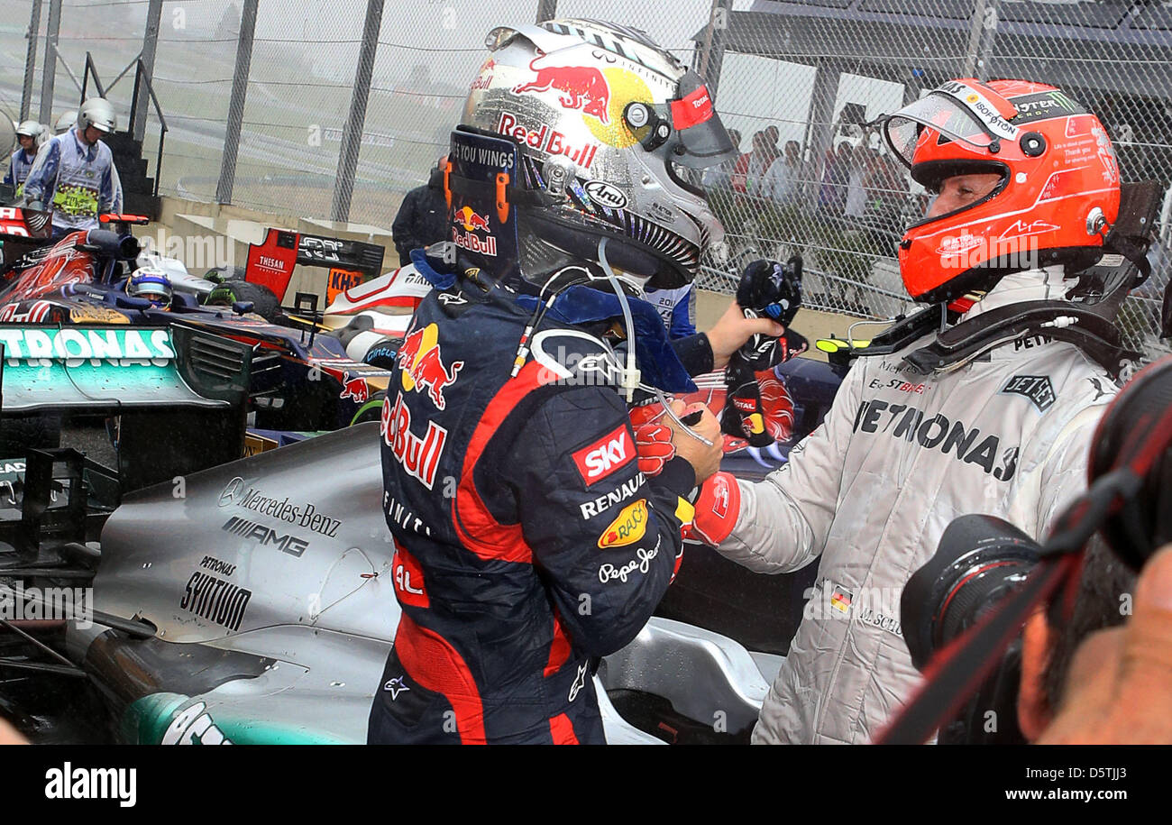 German Formula One driver Sebastian Vettel of Red Bull (L) celebrates ...