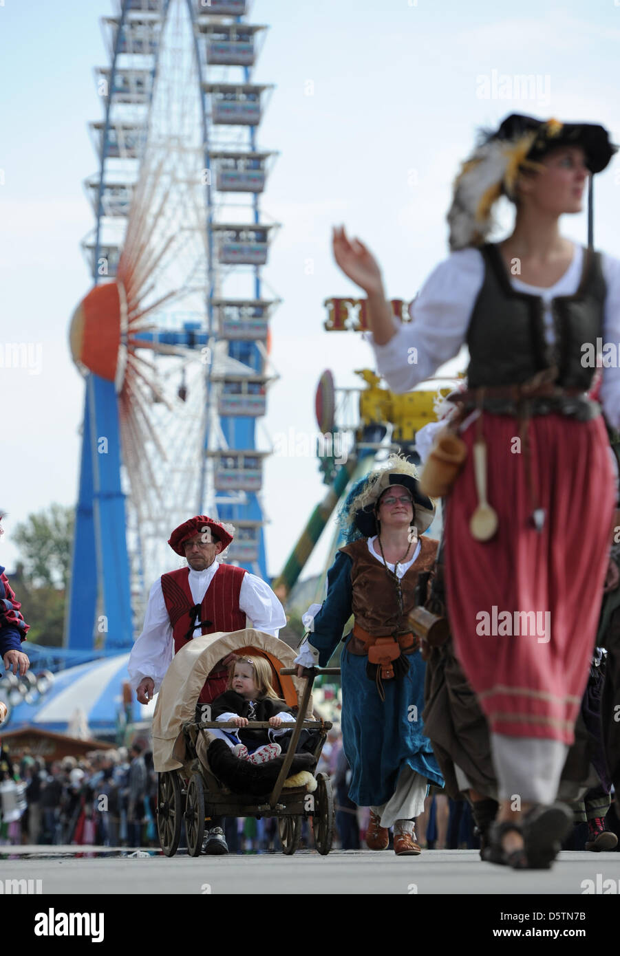 Men and women in traditional Bavarian costumes attend the traditional ...