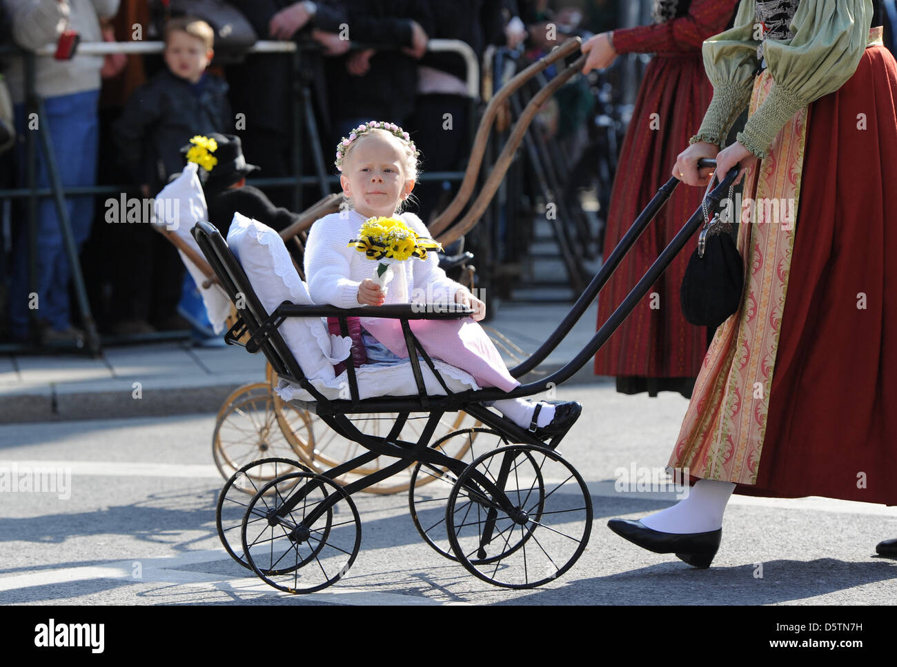 A baby in a historic buggy attends the traditional costume parade at ...