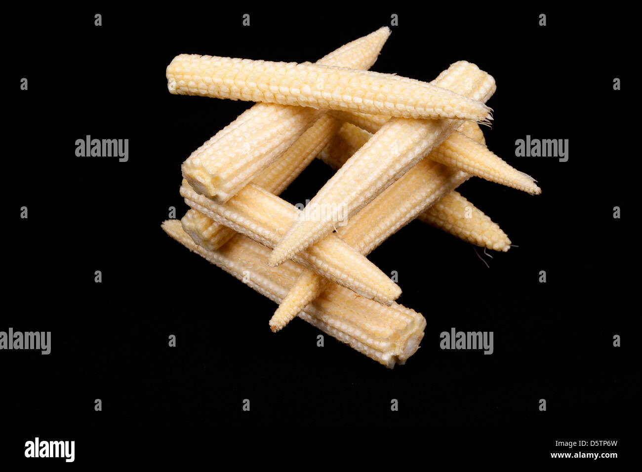 Baby corn isolated on black background Stock Photo - Alamy