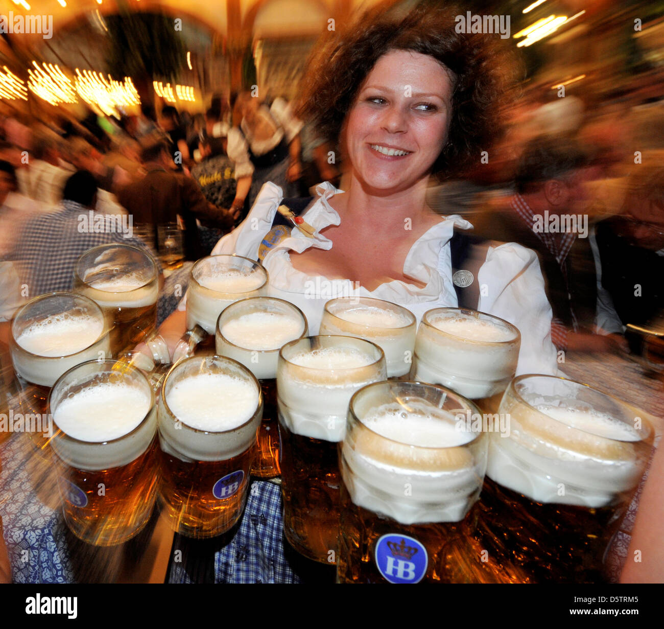 Waitress Helga serves eleven beer mugs in the Hofbraeu tent at the ...