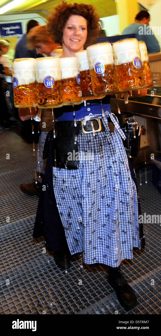 Waitress Helga serves eleven beer mugs in the Hofbraeu tent at the ...