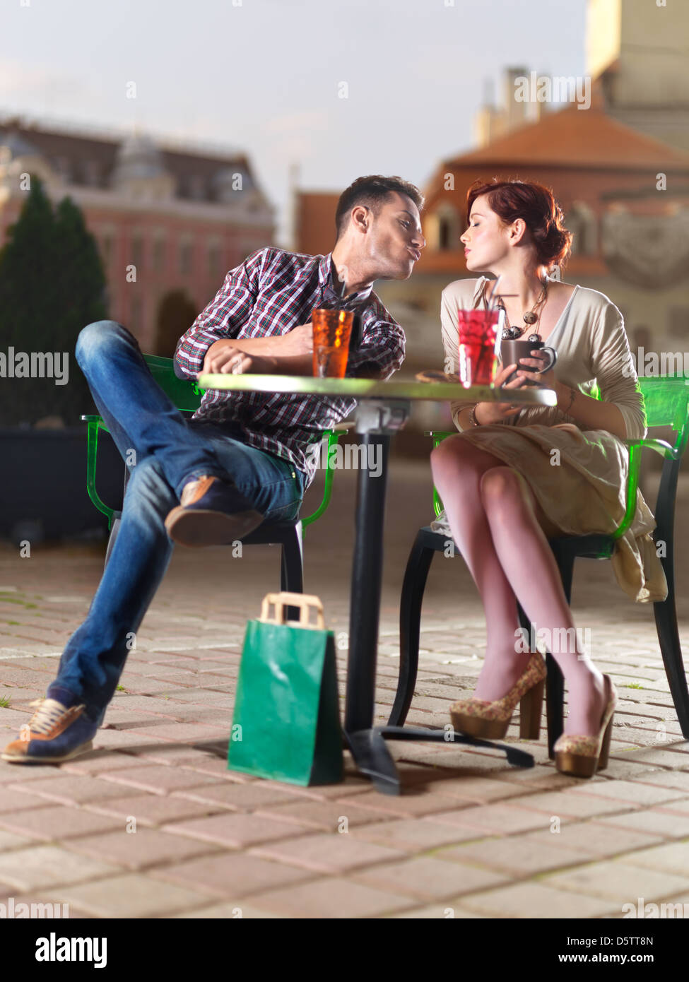 couple in love on the terrace rests in the town square Stock Photo - Alamy