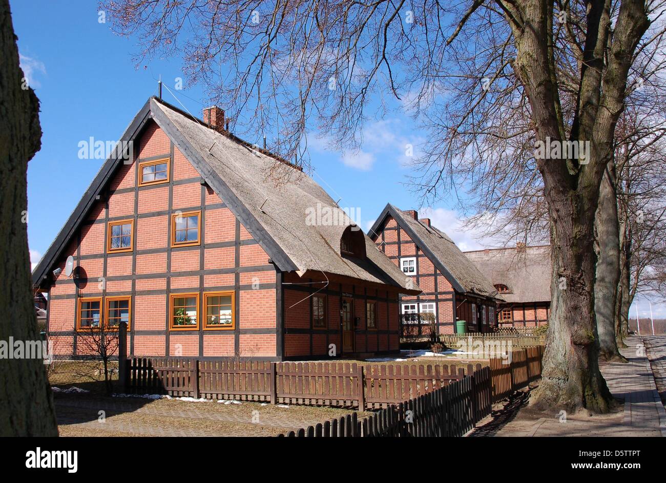 The typical timber frame buildings with thatched rooves are pictured in ...