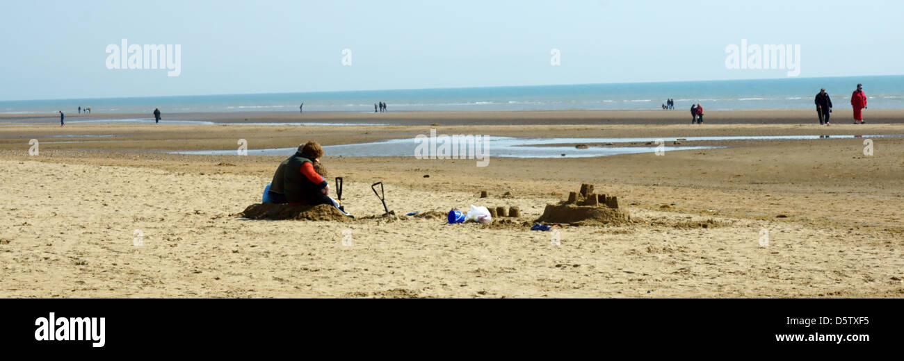 camber sands fat people building sand castles Stock Photo - Alamy