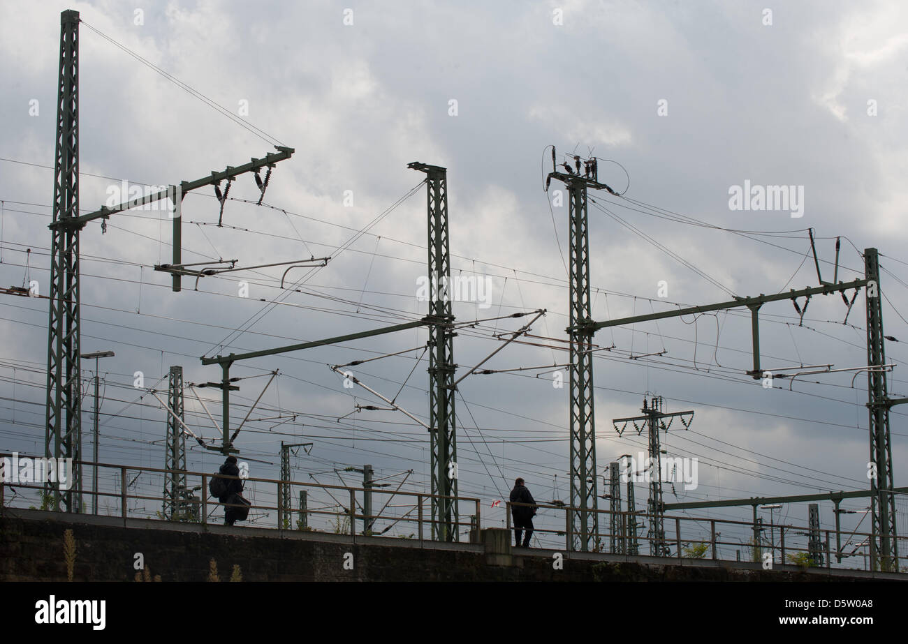 Passengers walk on the railway embankment after being evacuated from a ...