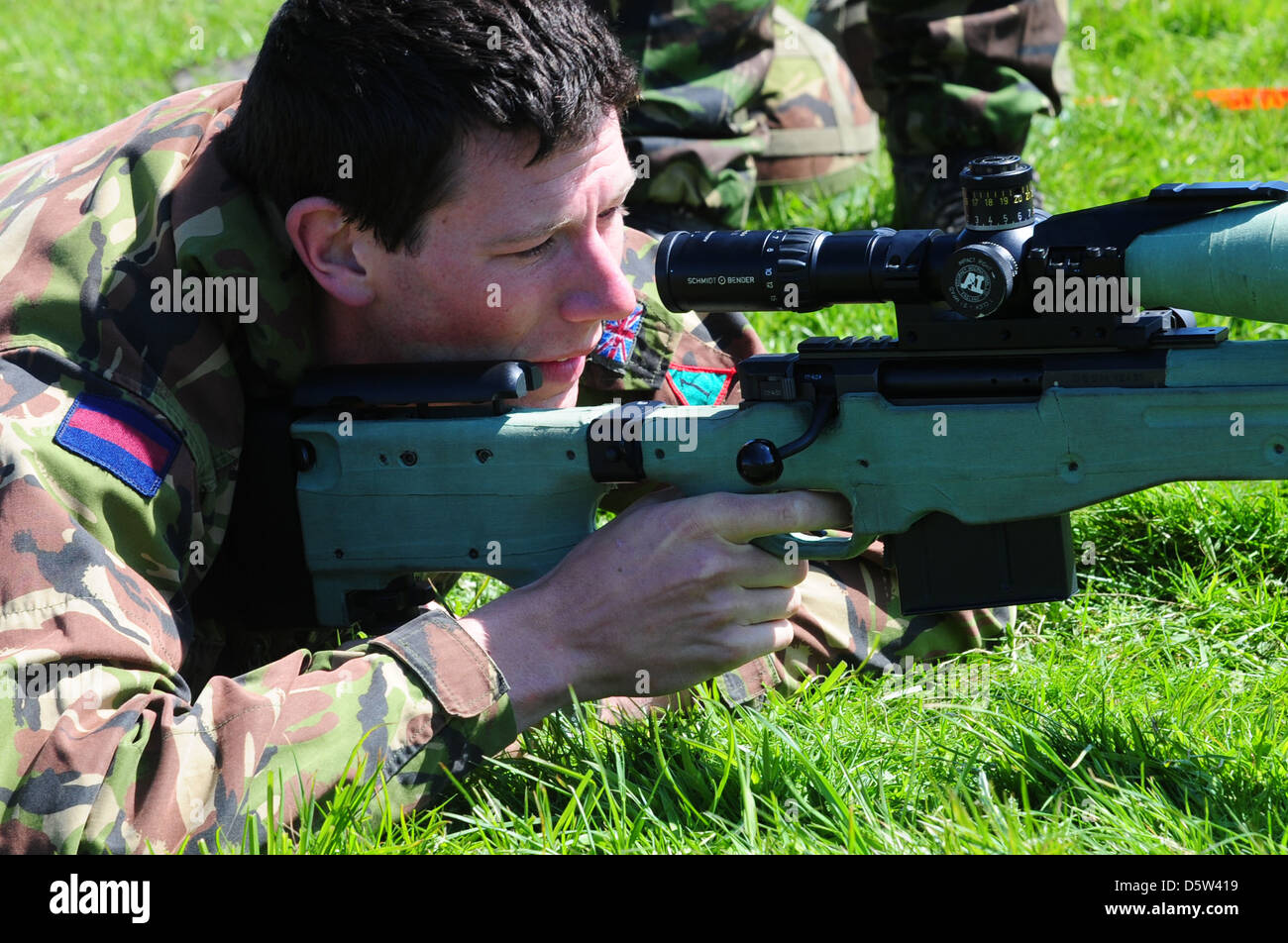 British infantry soldier is seen looking down the telescopic sight of ...