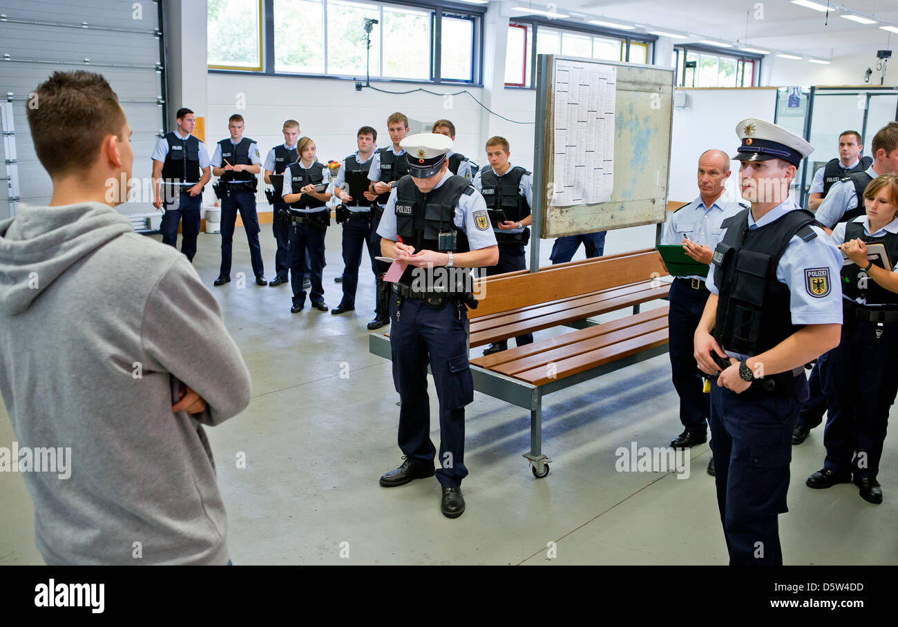 Police officer trainees practice scenes from the daily life of a police ...