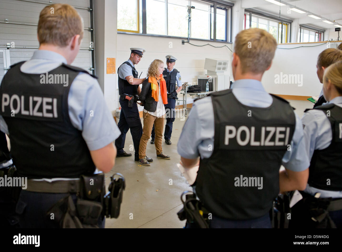 Police officer trainees practice scenes from the daily life of a police ...