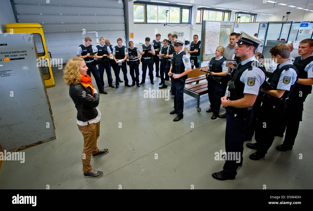 Police officer trainees practice scenes from the daily life of a police ...