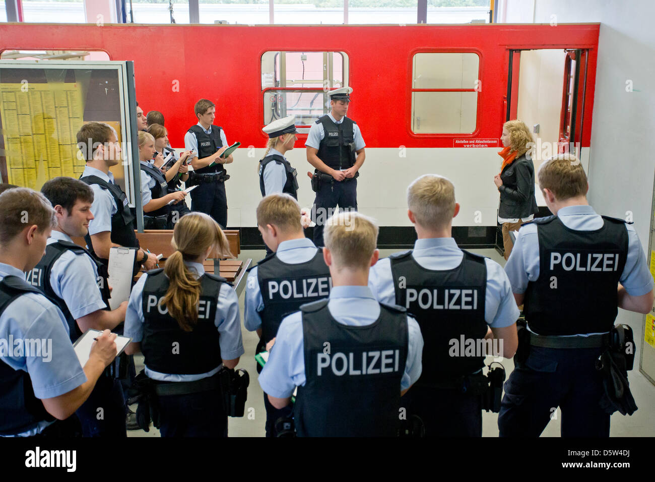 Police officer trainees practice scenes from the daily life of a police ...
