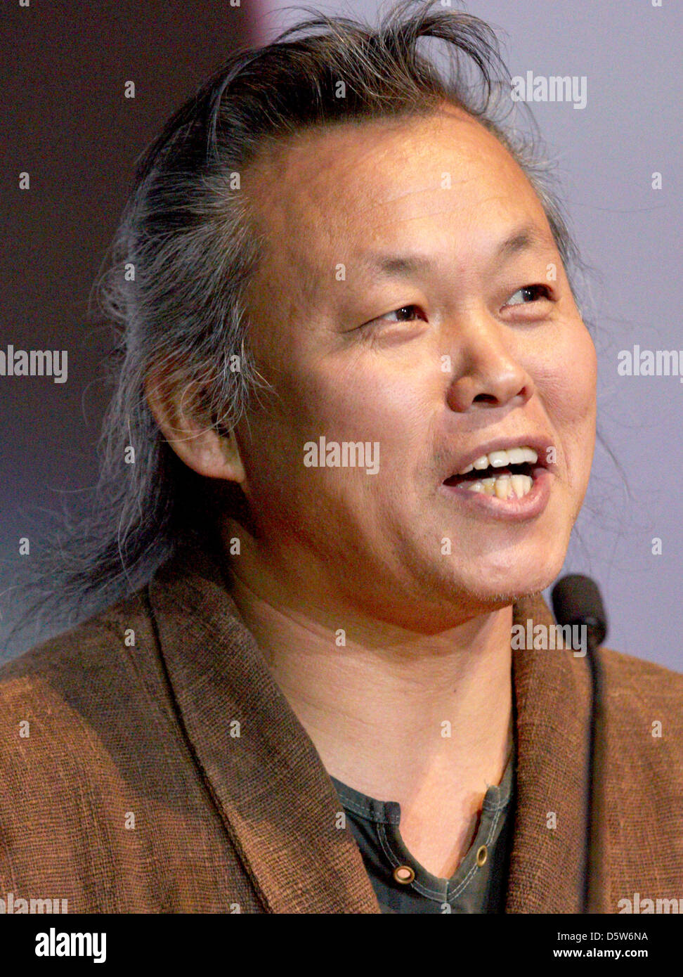 South Korean director Kim Ki-duk sings a song after he received the ...